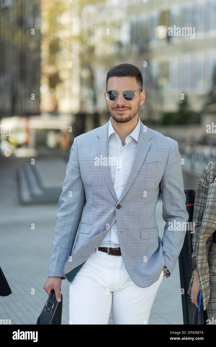 Handsome and attractive male boss is walking with his assistents Stock ...