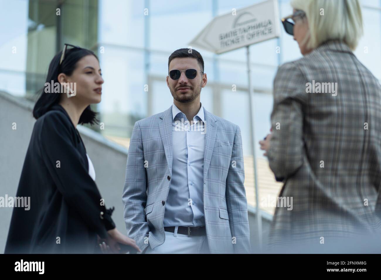 Three business people are talking about business while on their break ...
