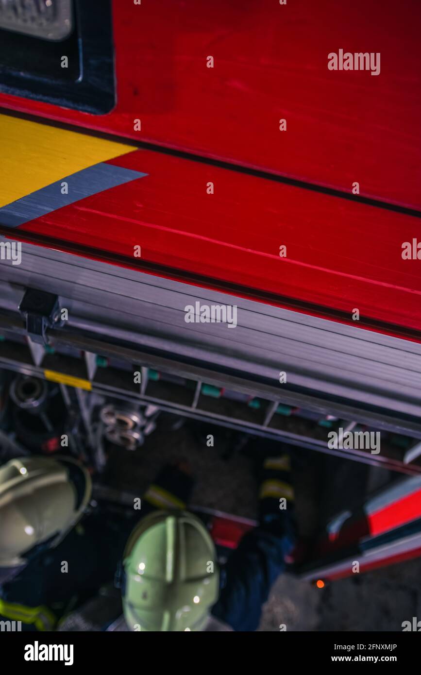 Firemen checking the fire engine inside the fire department from a bird ...