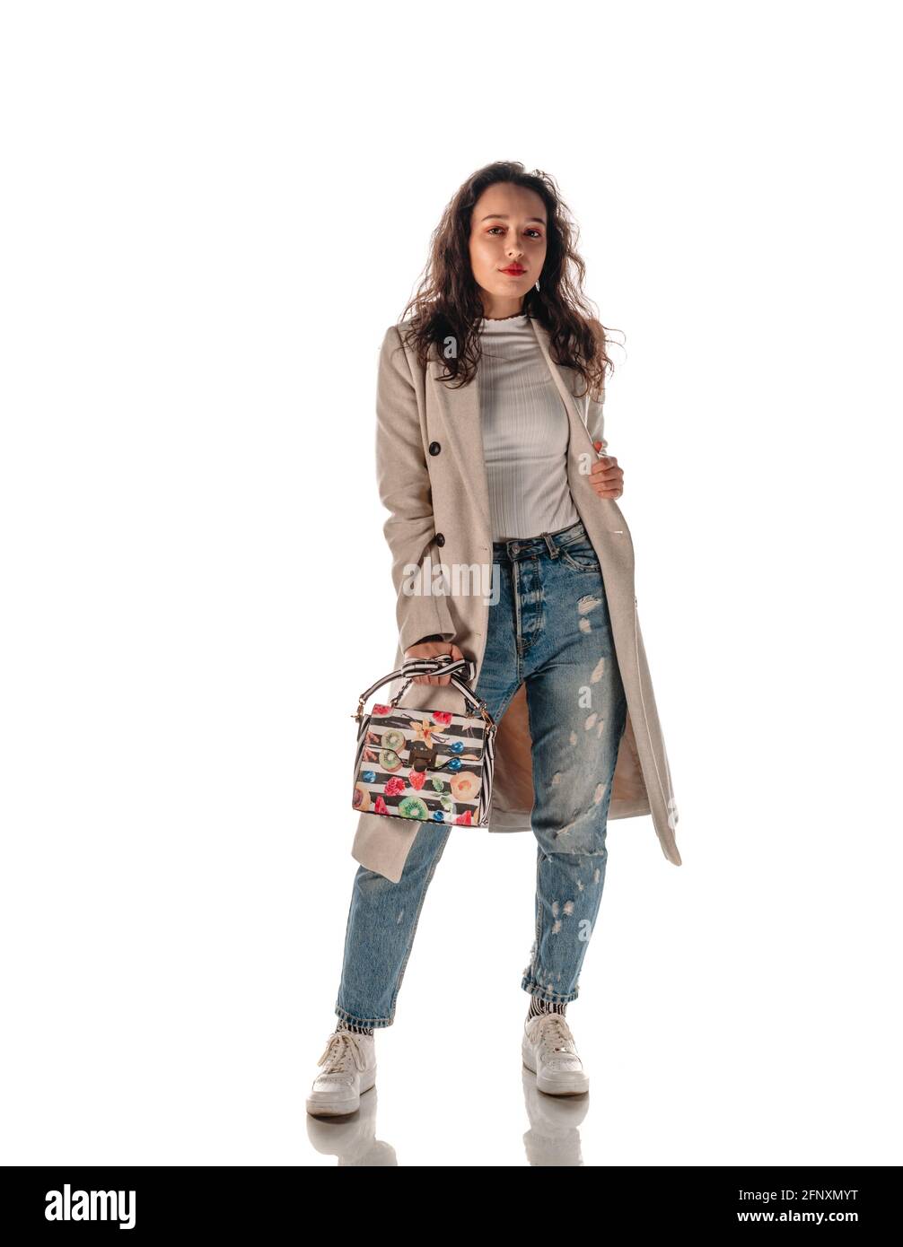 Portrait of a beautiful stylish girl posing in trendy modern clothes ...