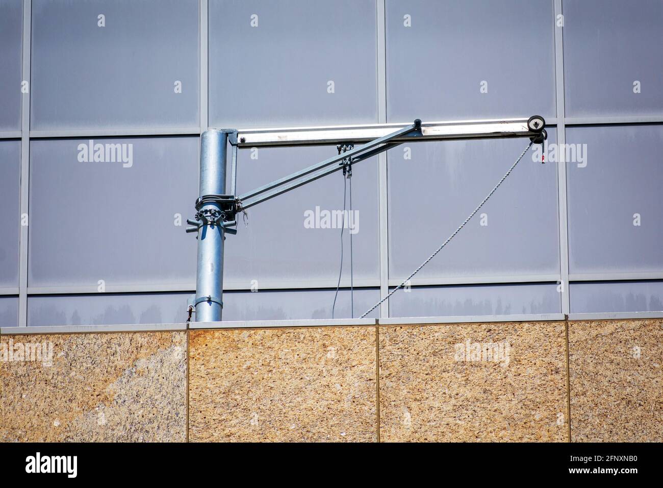 Swiveling davit arm is attached to the building roof structure Stock ...