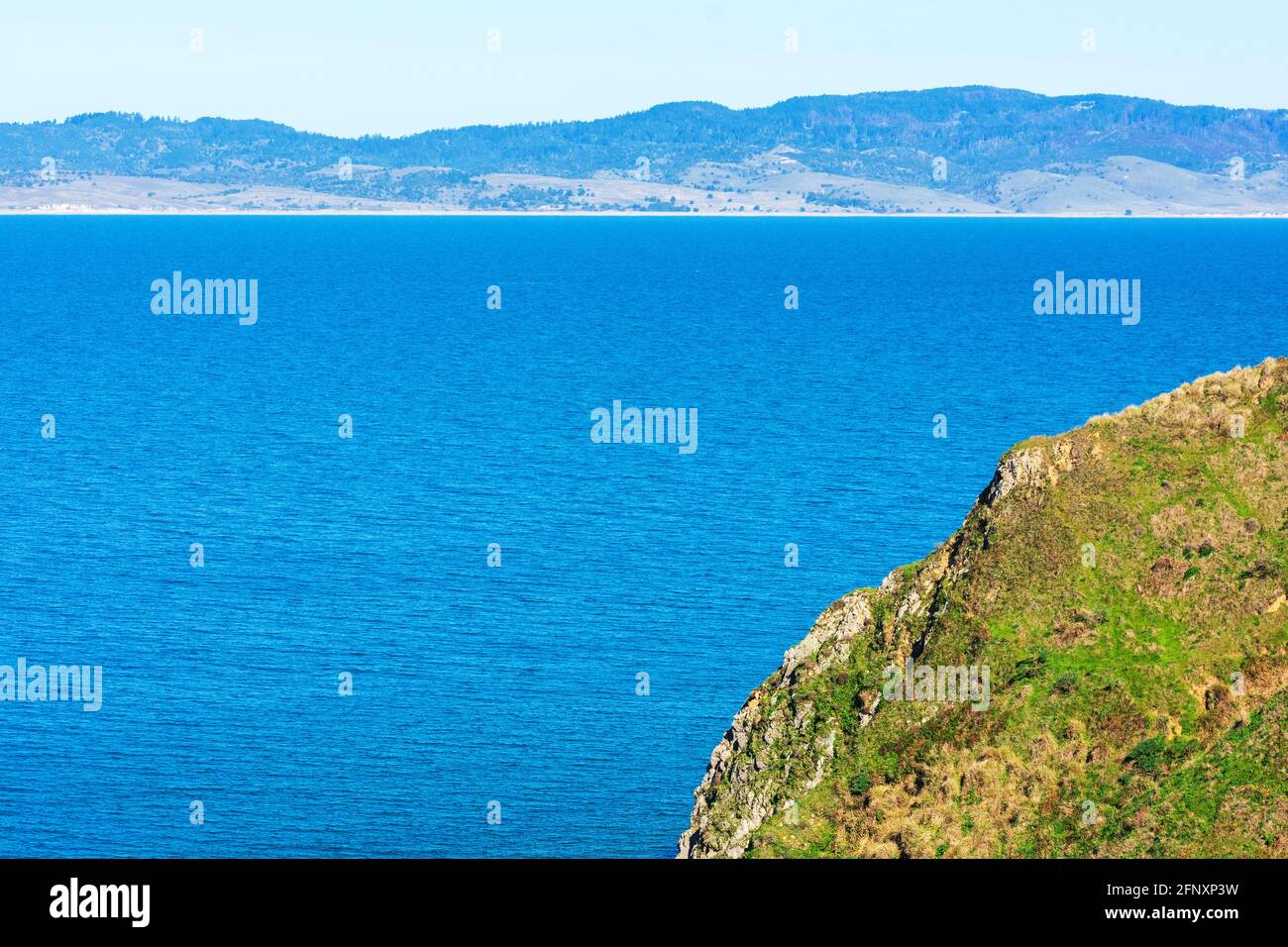 Dramatic cliff covered with green grass on a sunny day at Point Reyes ...
