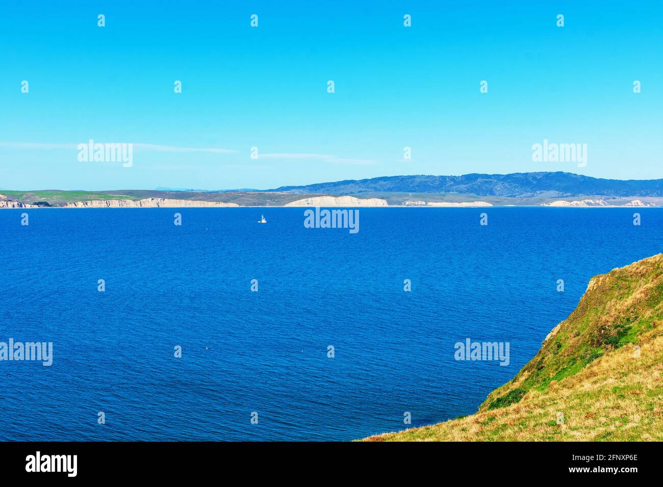 View of Drakes Bay calm water and coastline with dramatic white ...