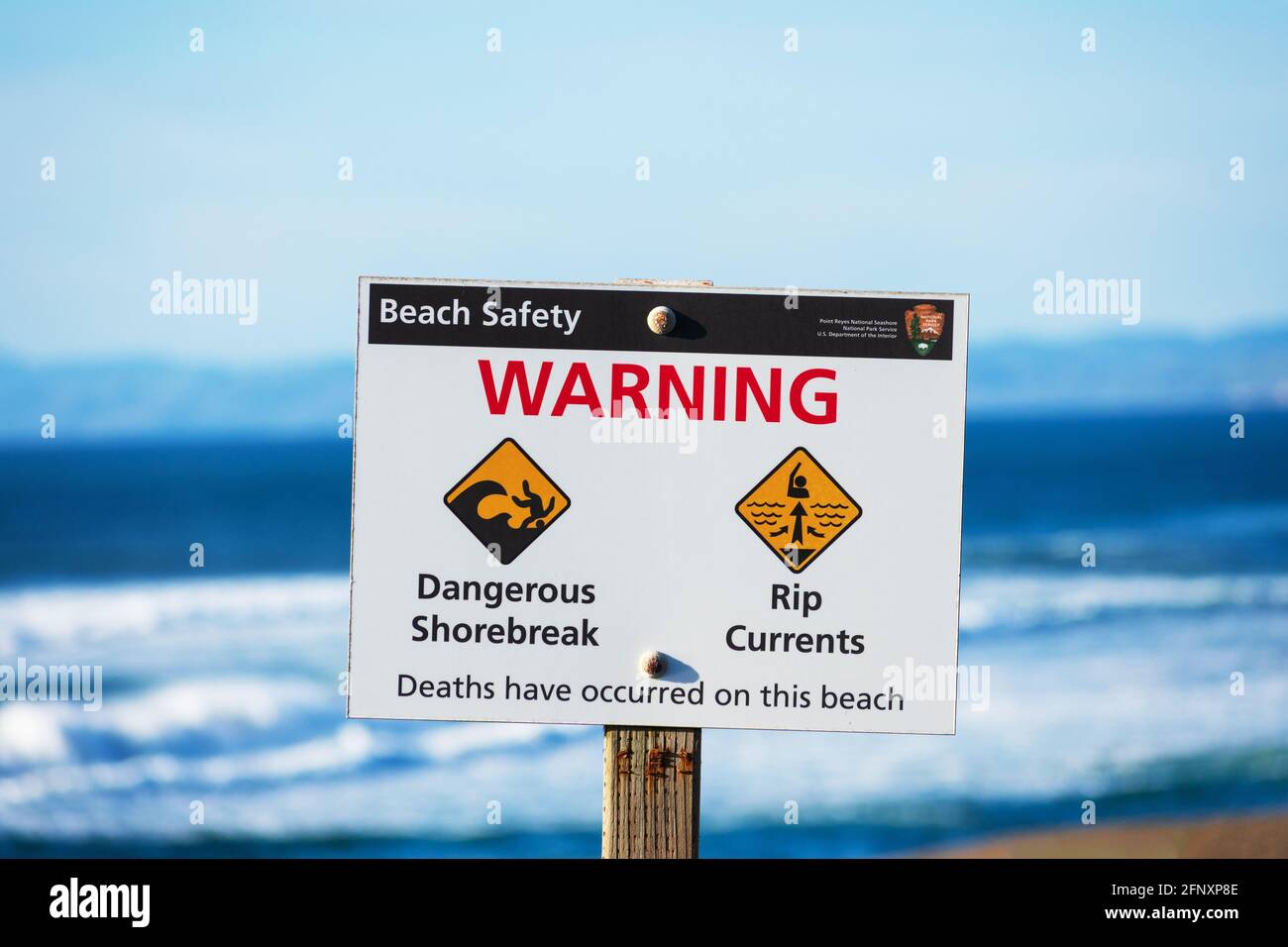 Beach safety warning sign informs visitors about dangerous shorebreak ...