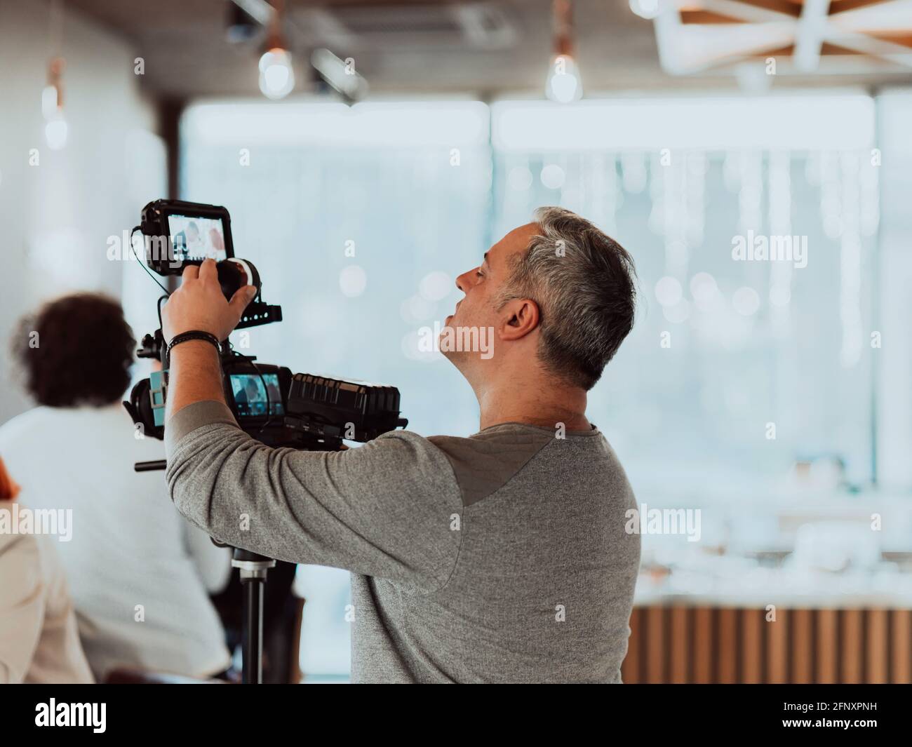 Cameraman working on professional camera taking stock footage Stock ...
