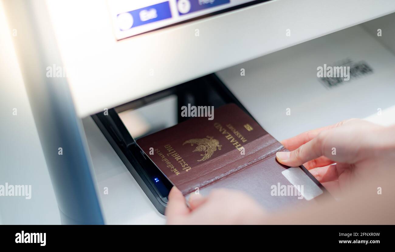 Female hand holding personal passport scaning at the self service ...