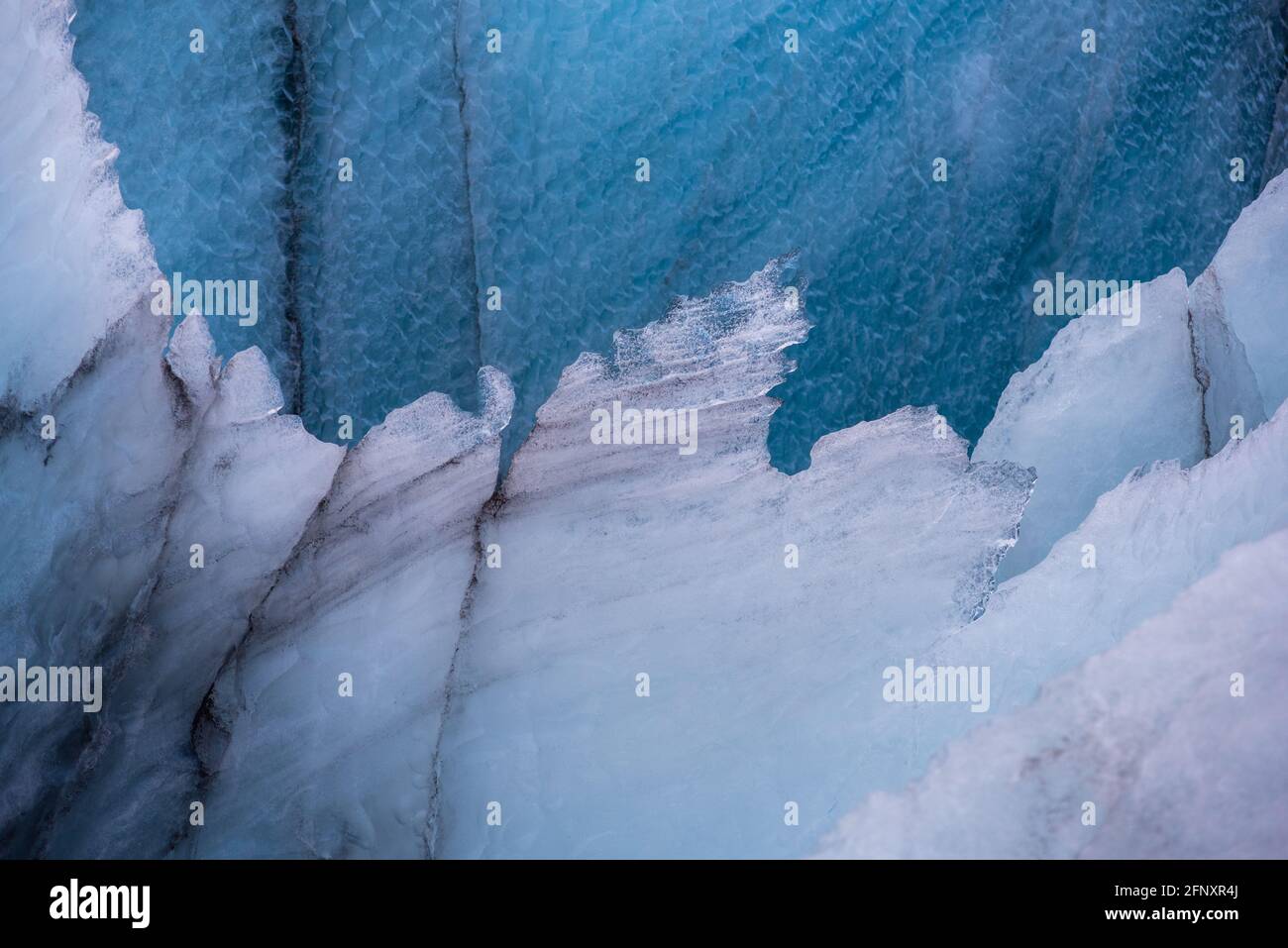 Detail close up of the edge of glacier snowflake like blue and white ...