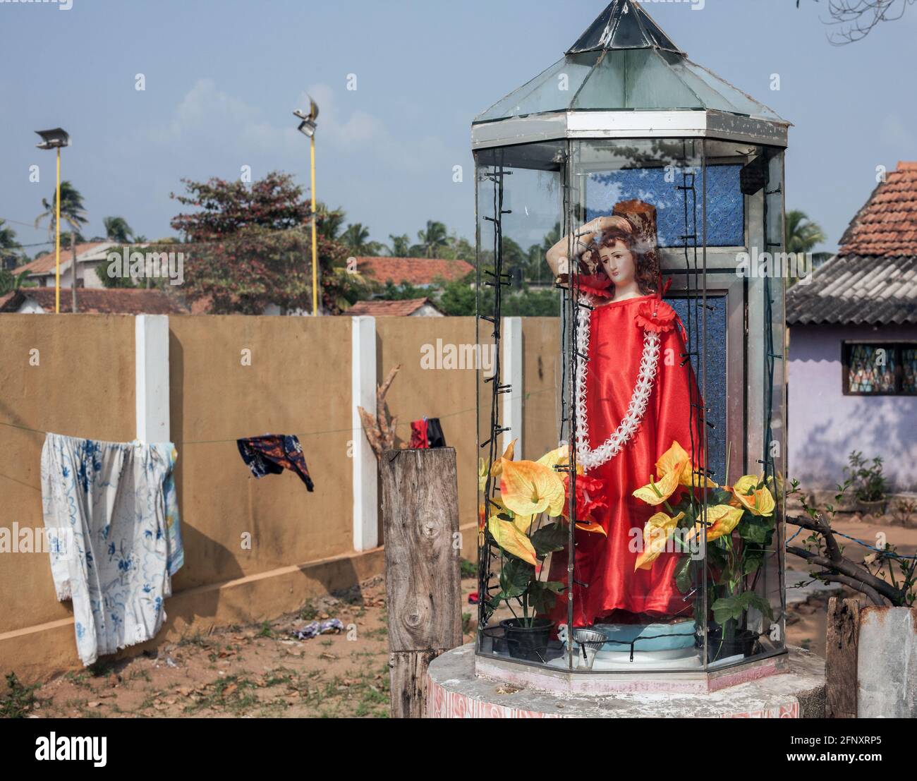 Figure of the Virgin Mary displayed in glass cabinet shrine outside ...