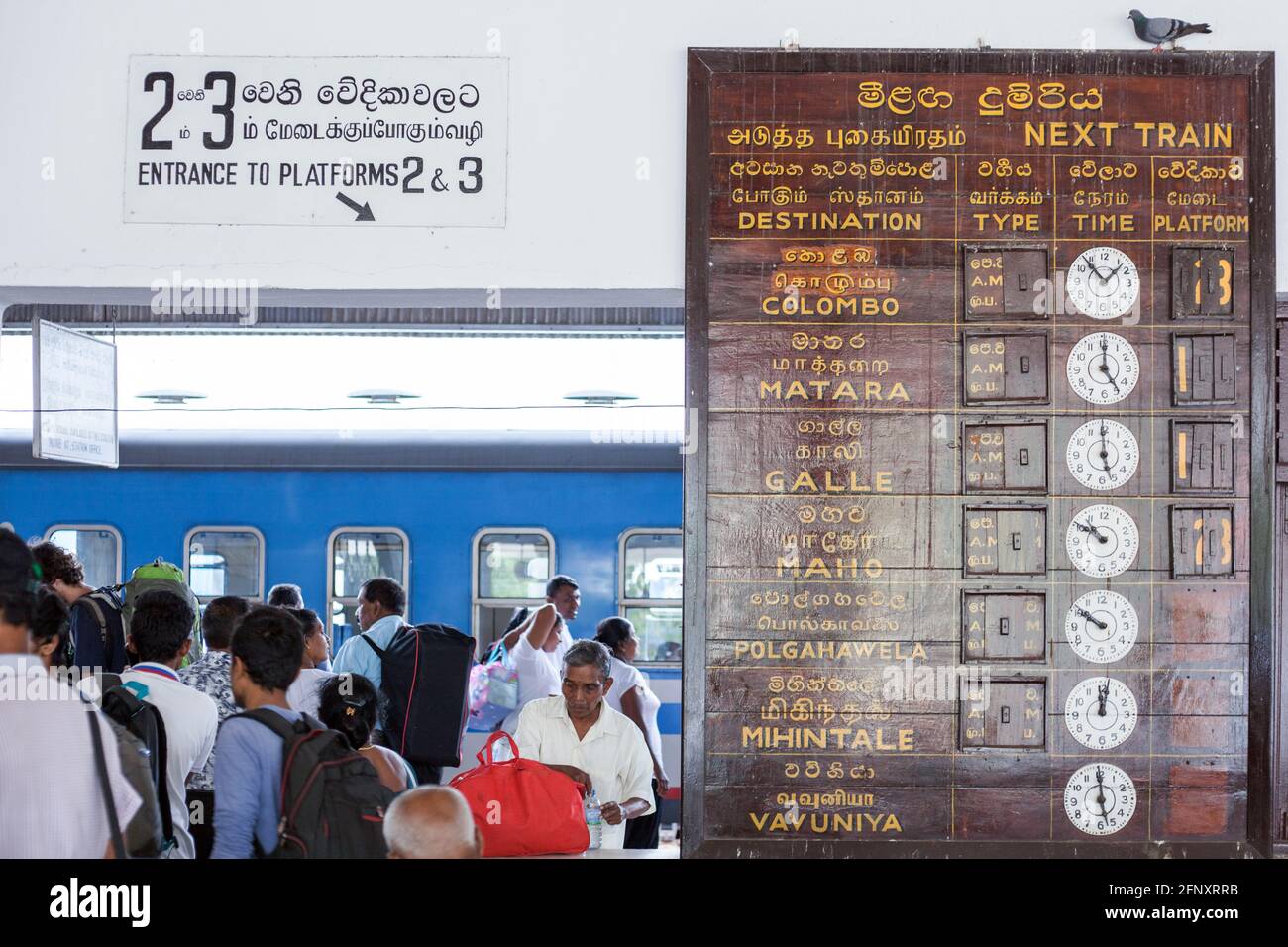Manual wooden departure board showing the timings of train destinations ...
