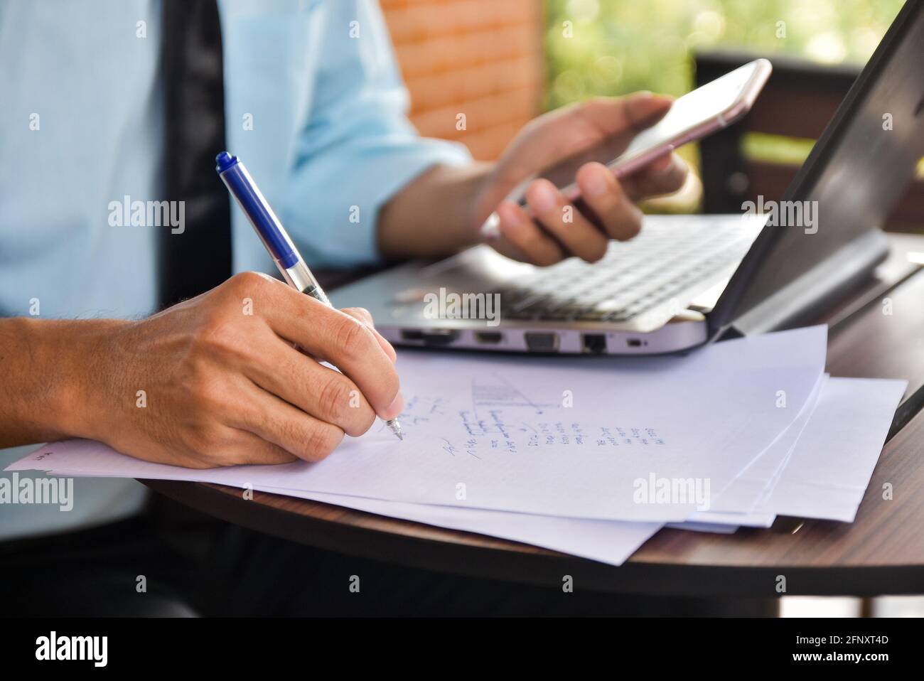 Close up hand pen writing paperwork, Businessman work computer ...