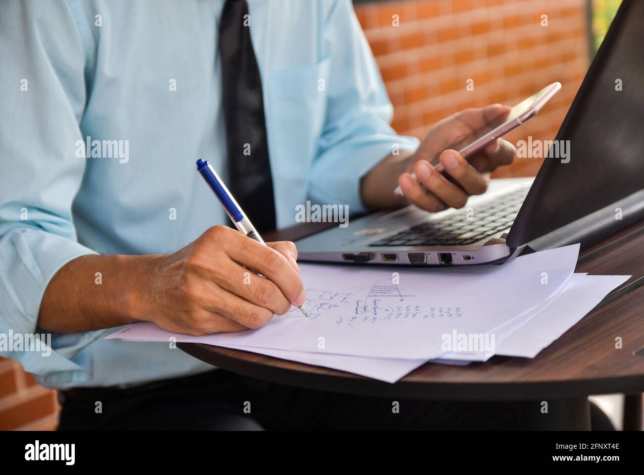 Close up hand pen writing paperwork, Businessman work computer ...