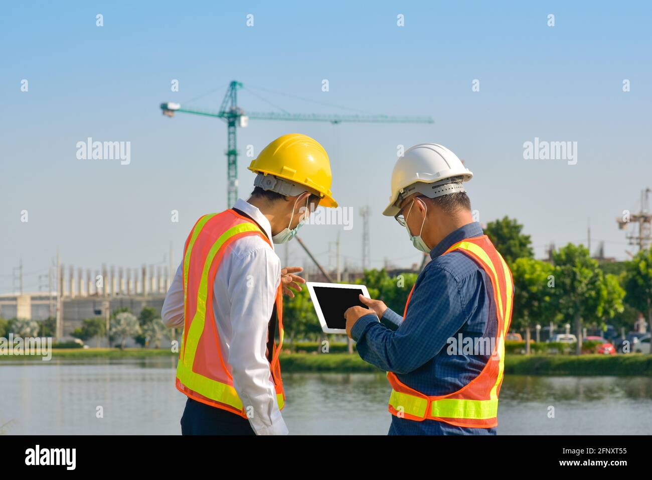 Two engineer worker tablet working on site construction, asian man ...
