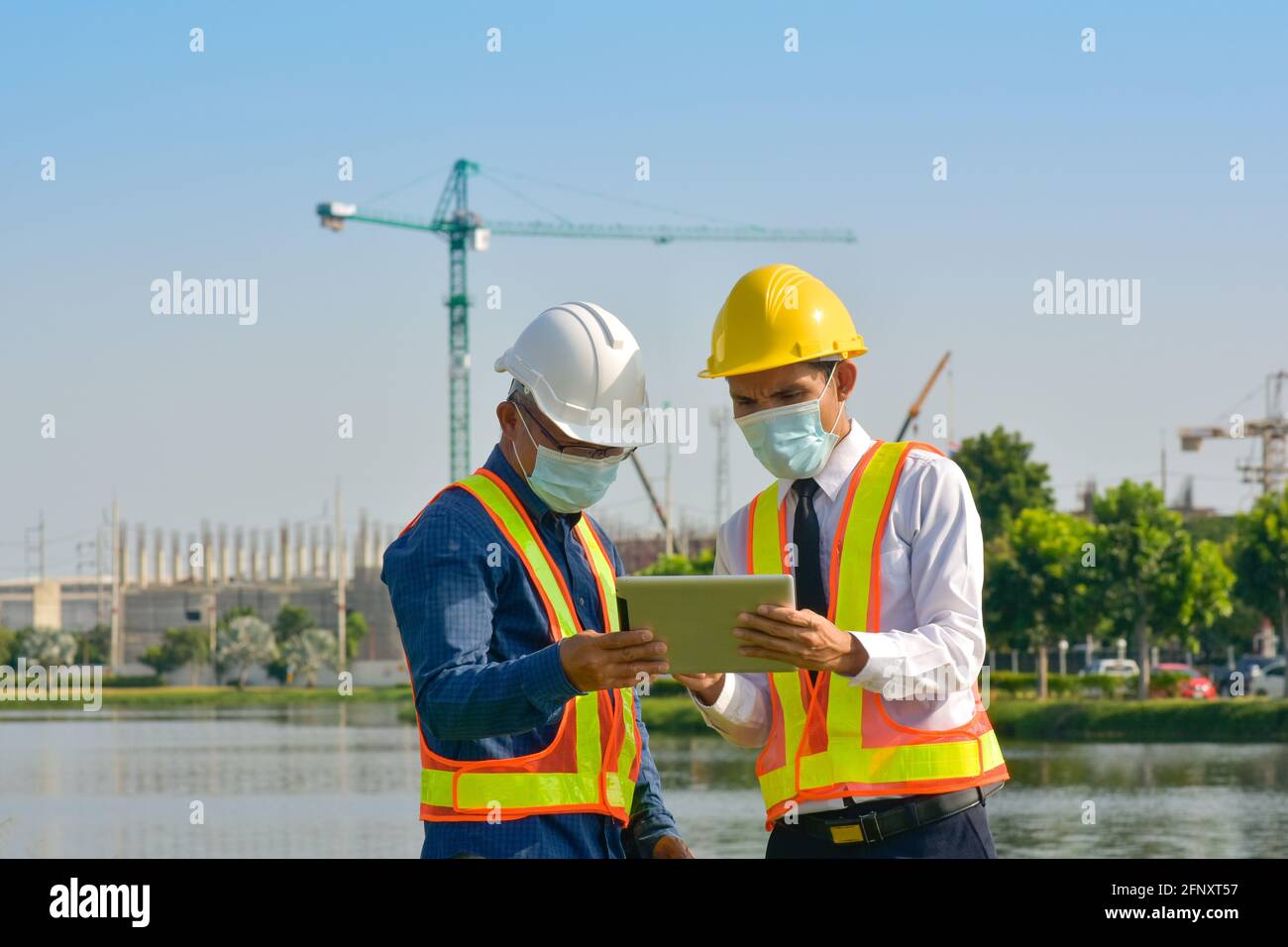 Two Engineer teamwork working tablet technology survey on site ...