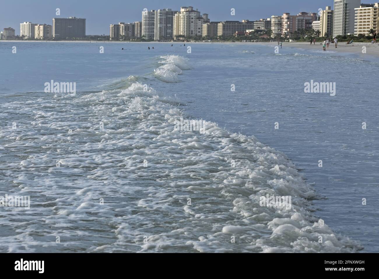 Wave on Marco Island beach Florida USA with people on the beach during ...