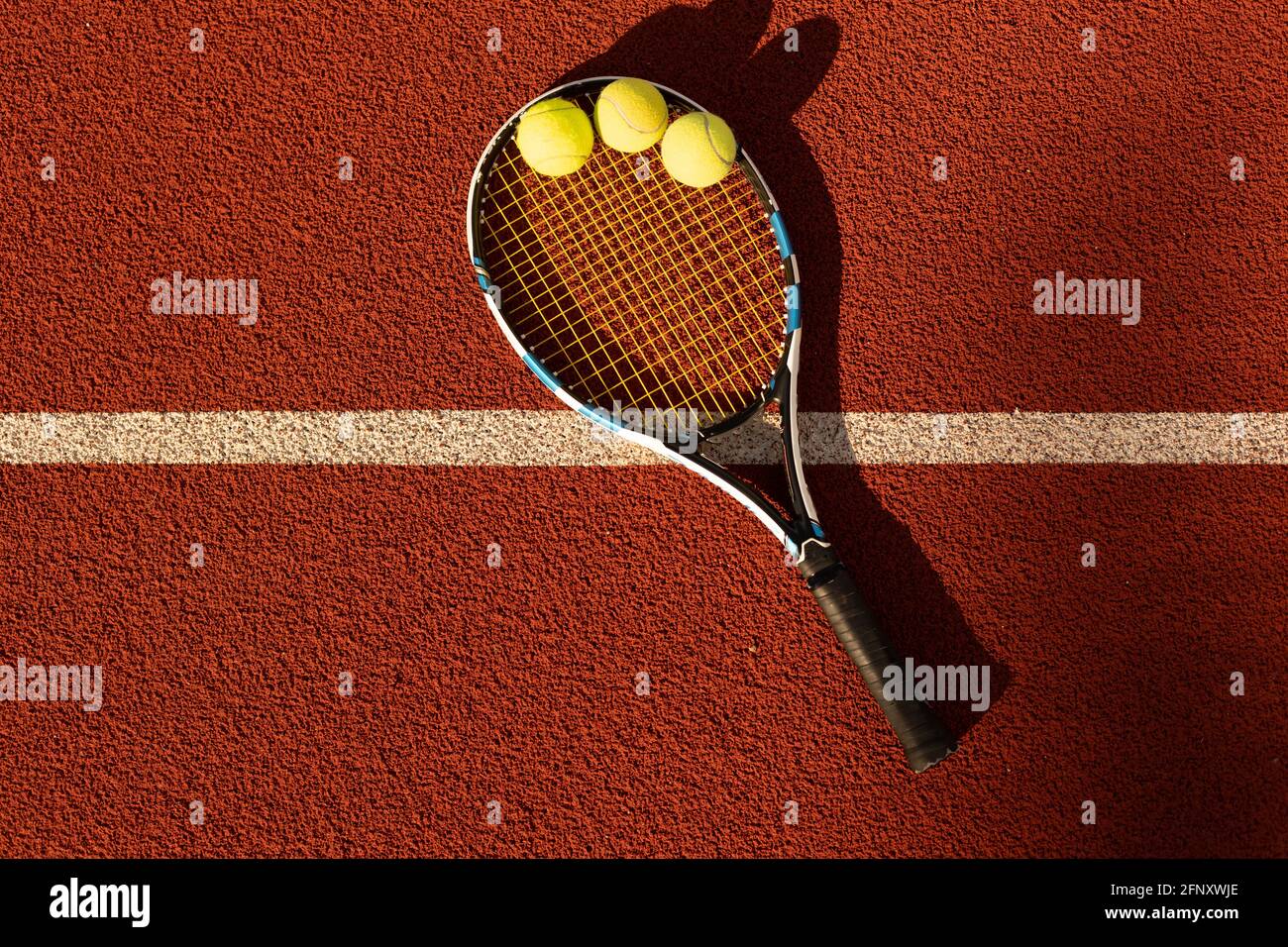 Tennis Ball with Racket on the racket in tennis court Stock Photo - Alamy