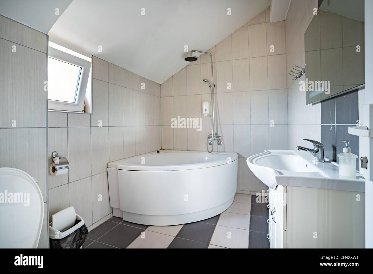 Bathroom bright toilet at home or hotel in day with sink and bath tub ...