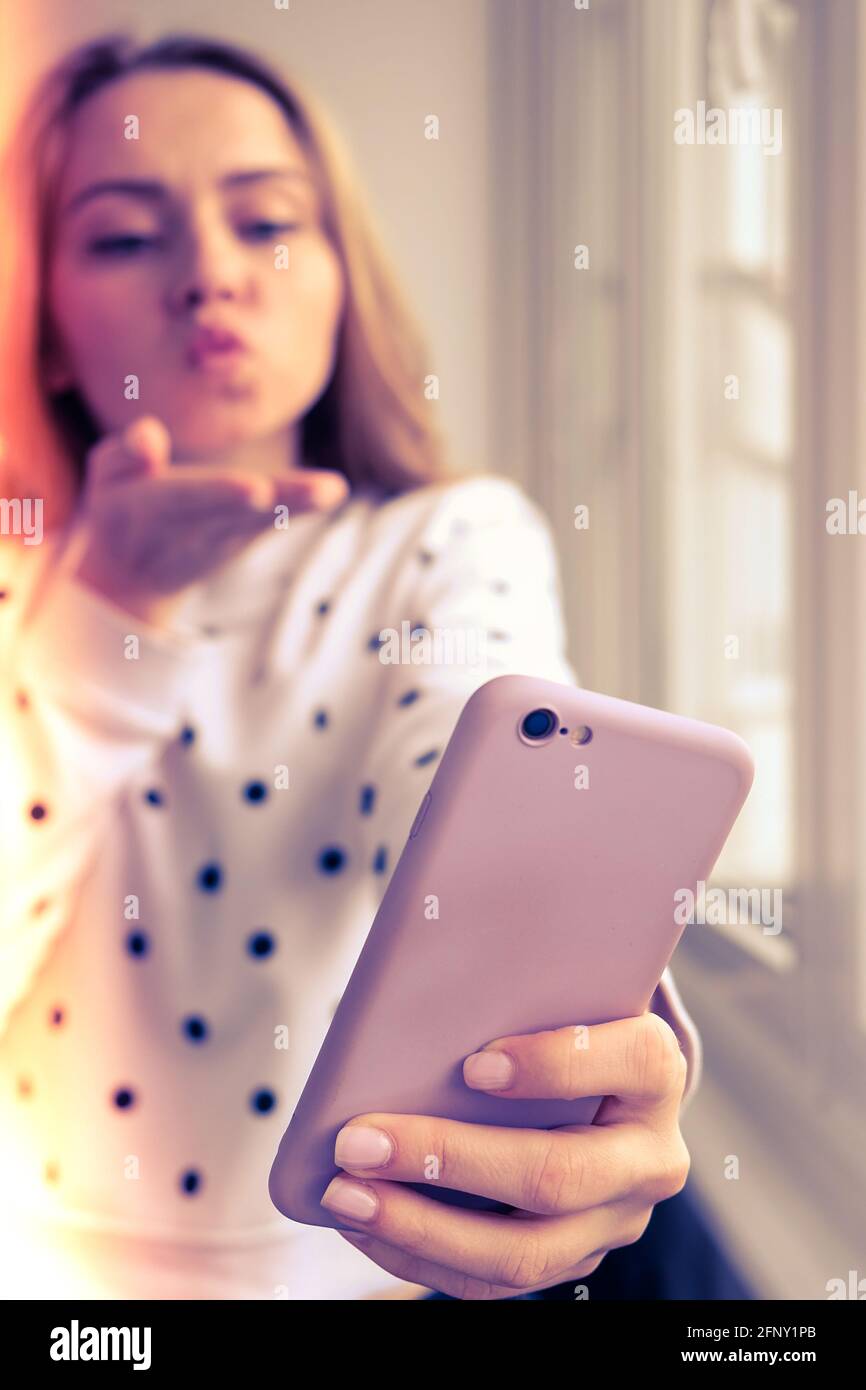 Blonde young girl taking selfie. Video call. Online education. Work ...