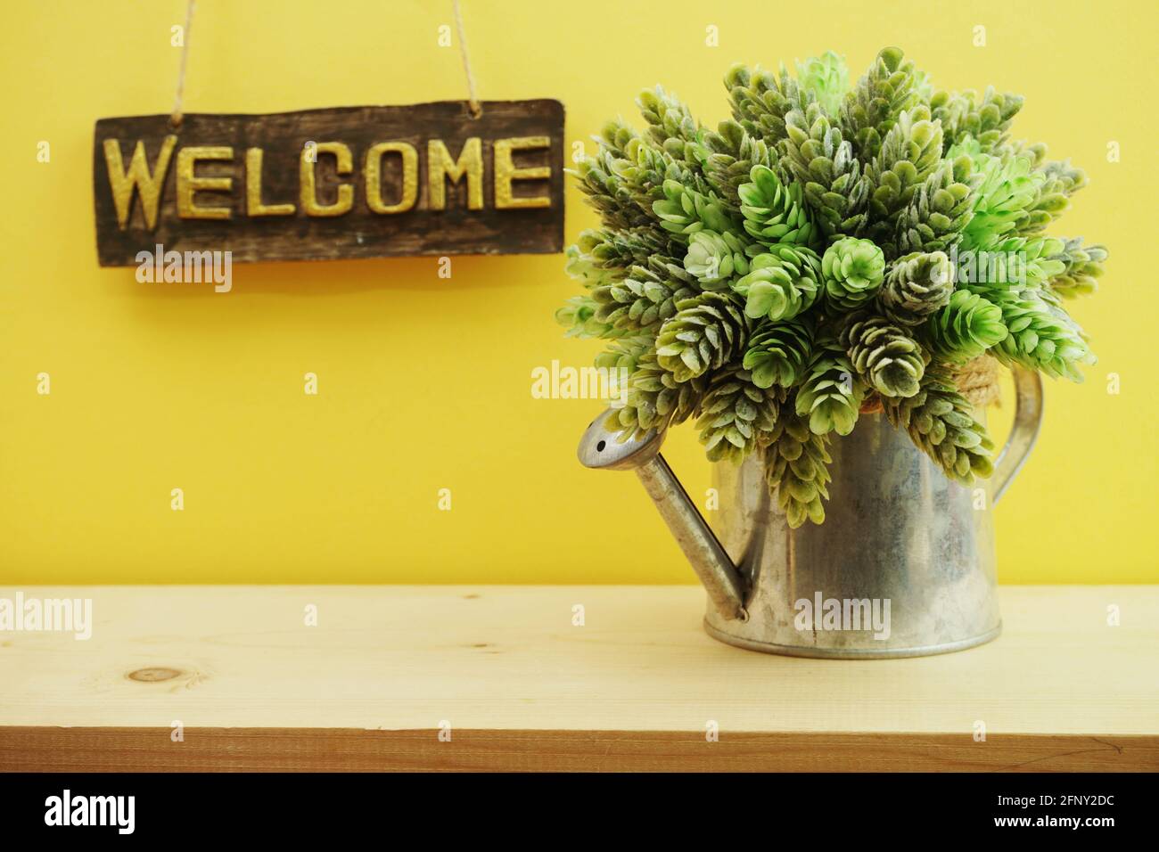 Welcome sign Hanging on yellow background Stock Photo - Alamy