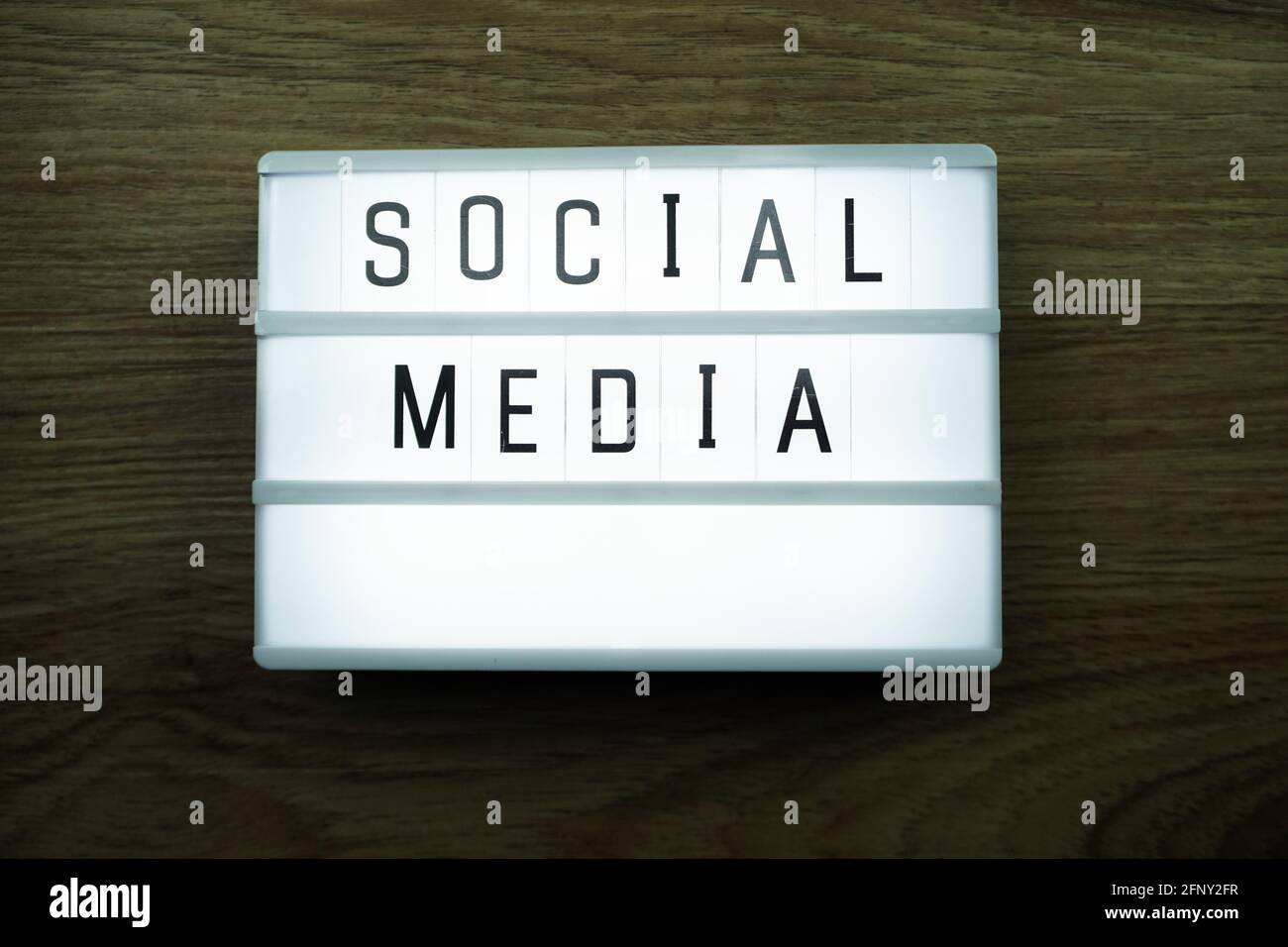 Social Media word in light box on wooden background Stock Photo - Alamy