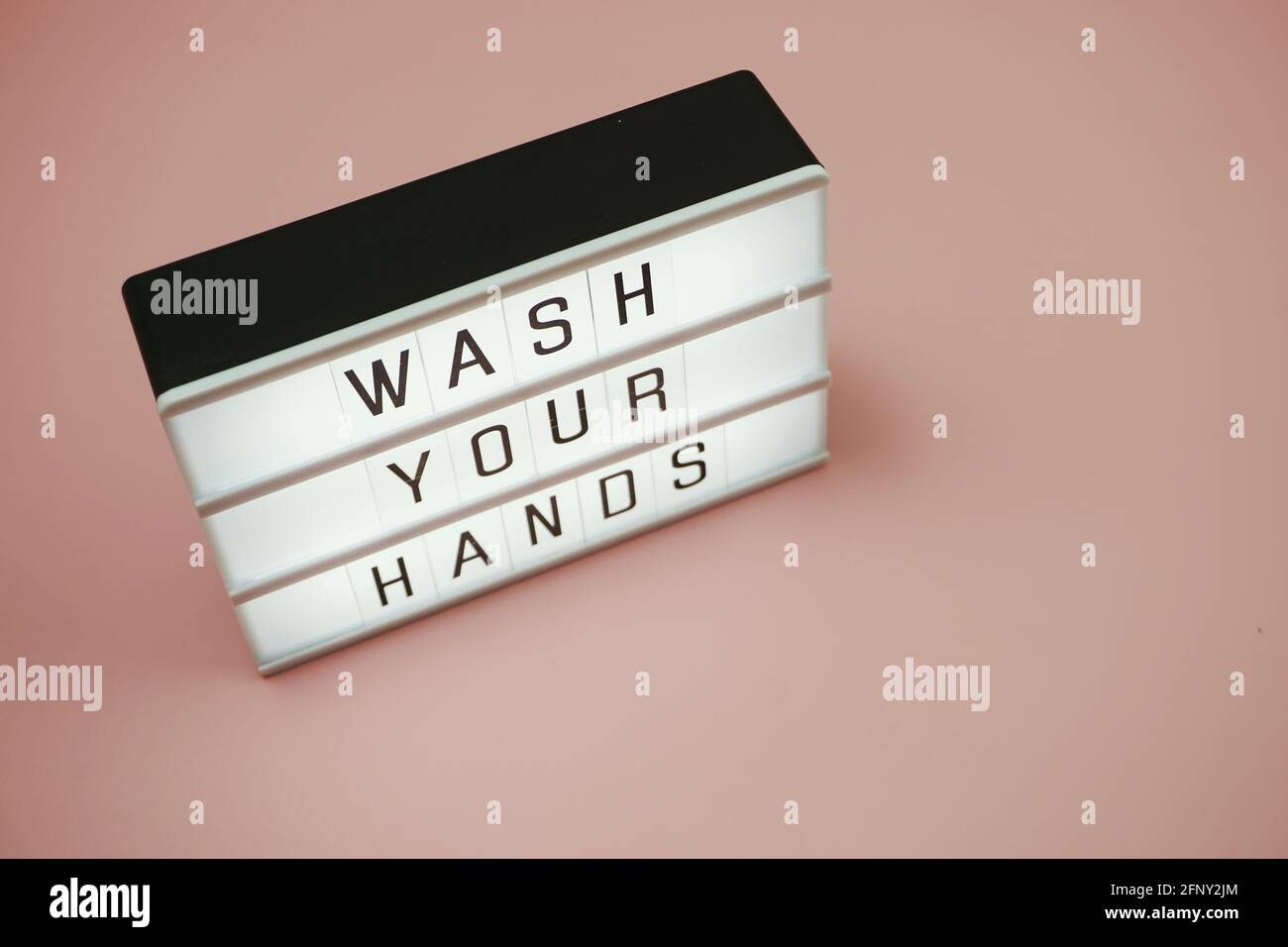 Flat lay Wash Your Hands word in light box with space coy on pink ...