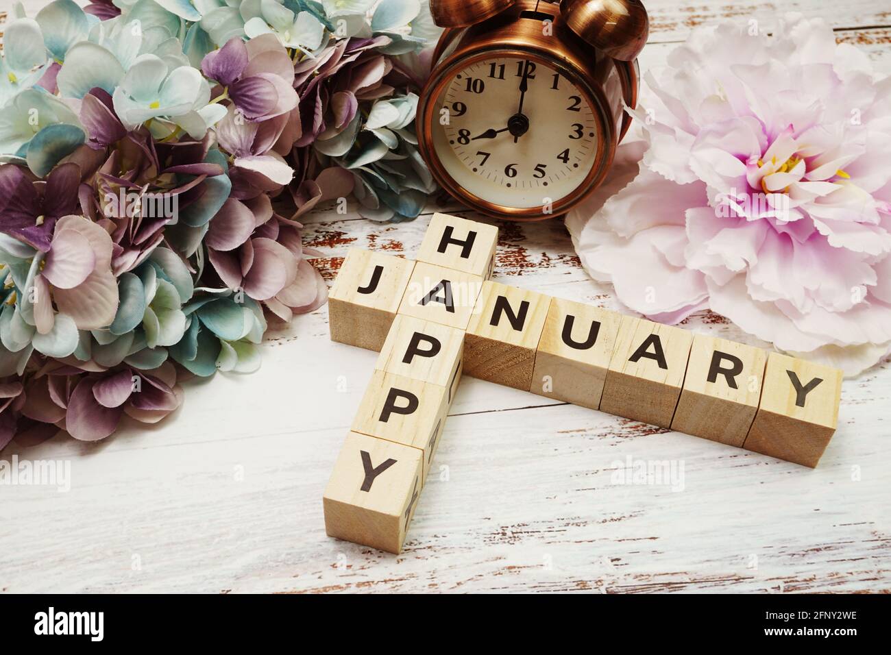 Happy January with alarm clock on wooden background Stock Photo - Alamy