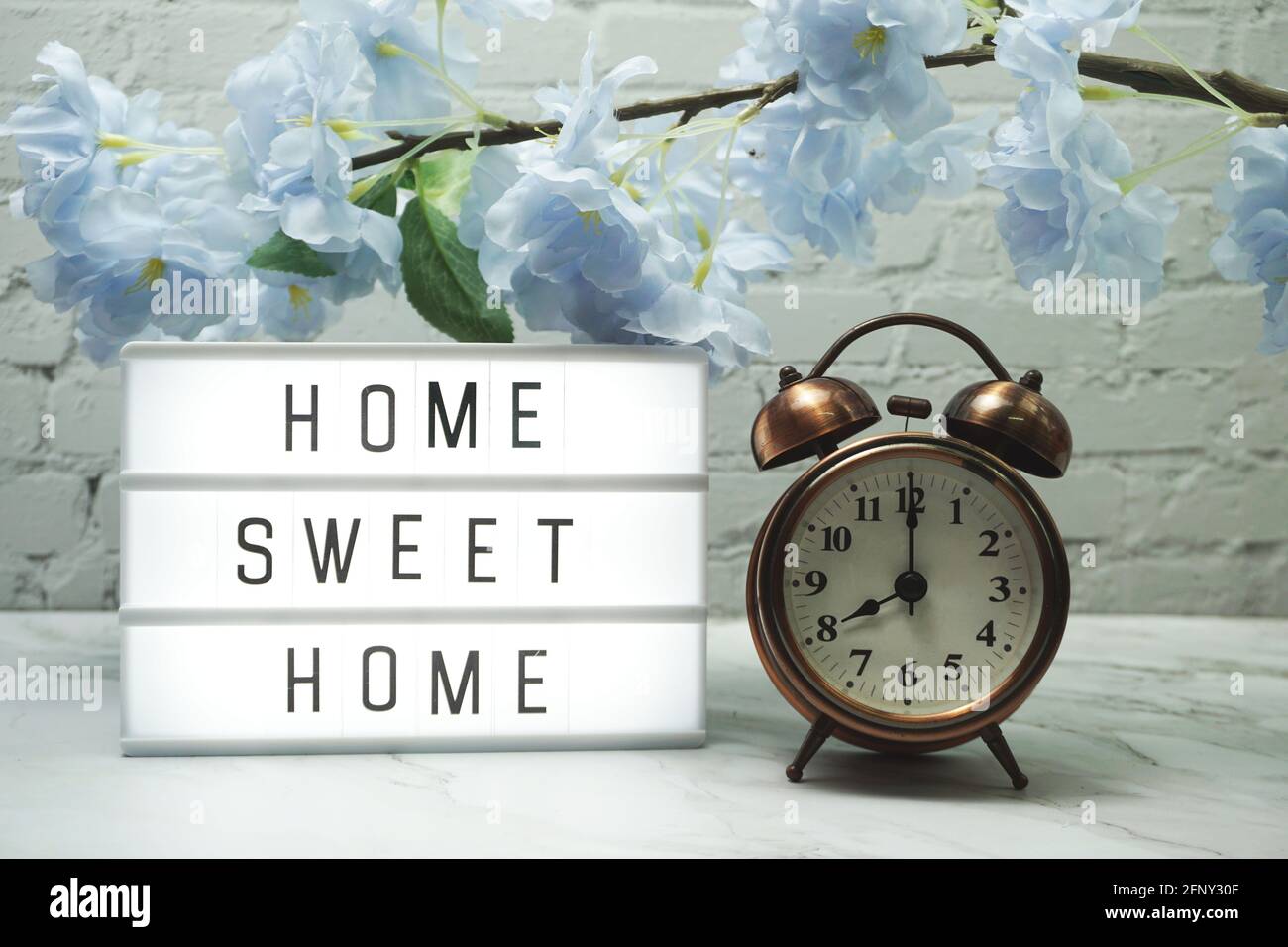 Home Sweet Home Word in light box and alarm clock with flowers ...