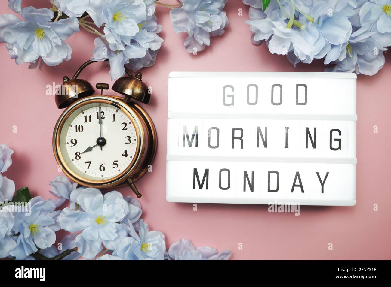 Good Morning Monday word in light box with Flowers Decoration on pink ...