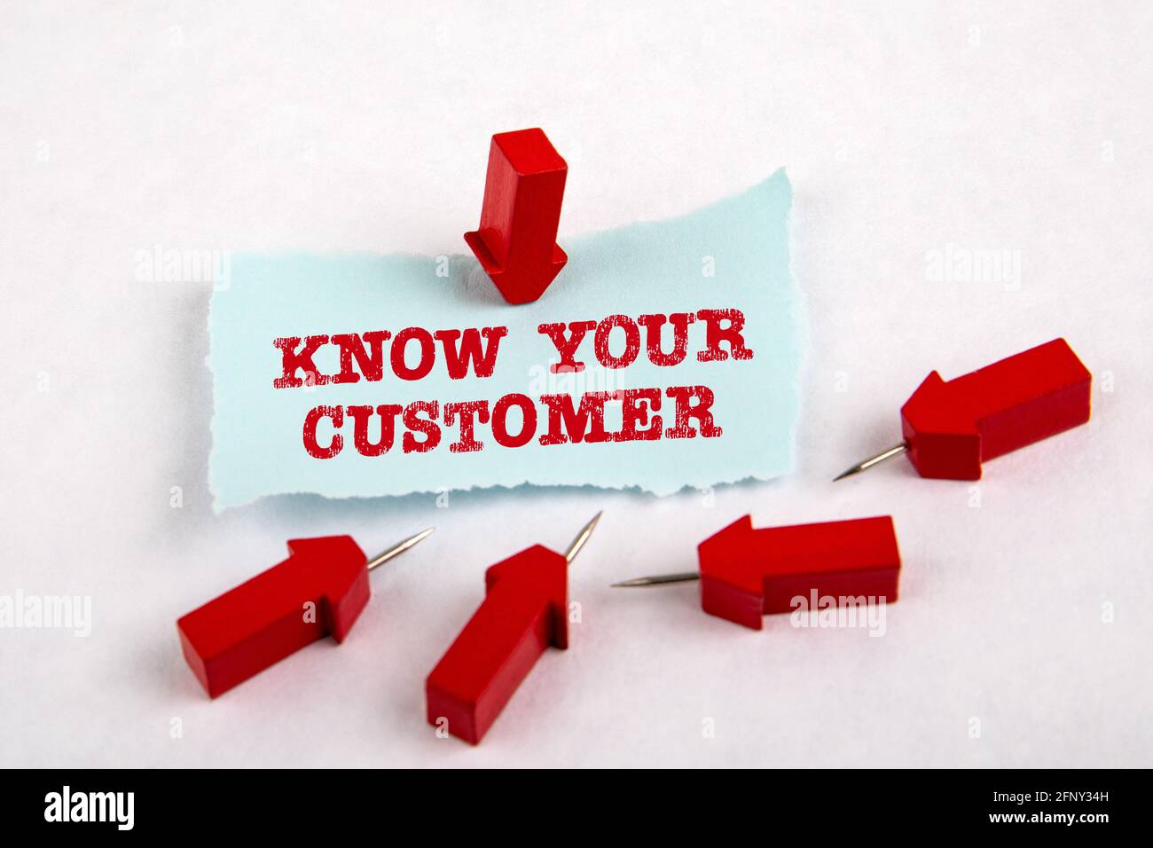 KNOW YOUR CUSTOMER. Note sheet and red arrows on white paper Stock ...
