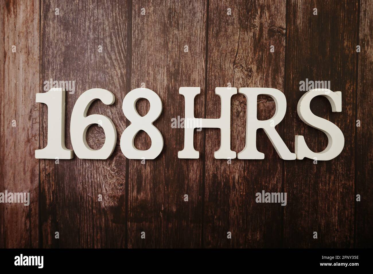 168 HRS Number of hours in a week with space copy on wooden background ...