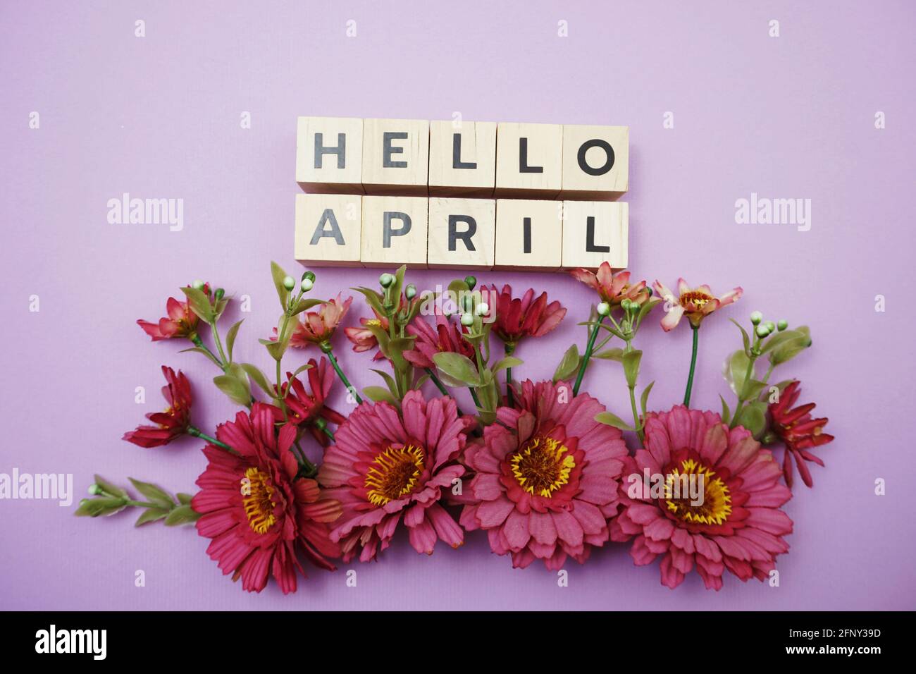 Hello April alphabet letters with pink flower decoration on purple ...