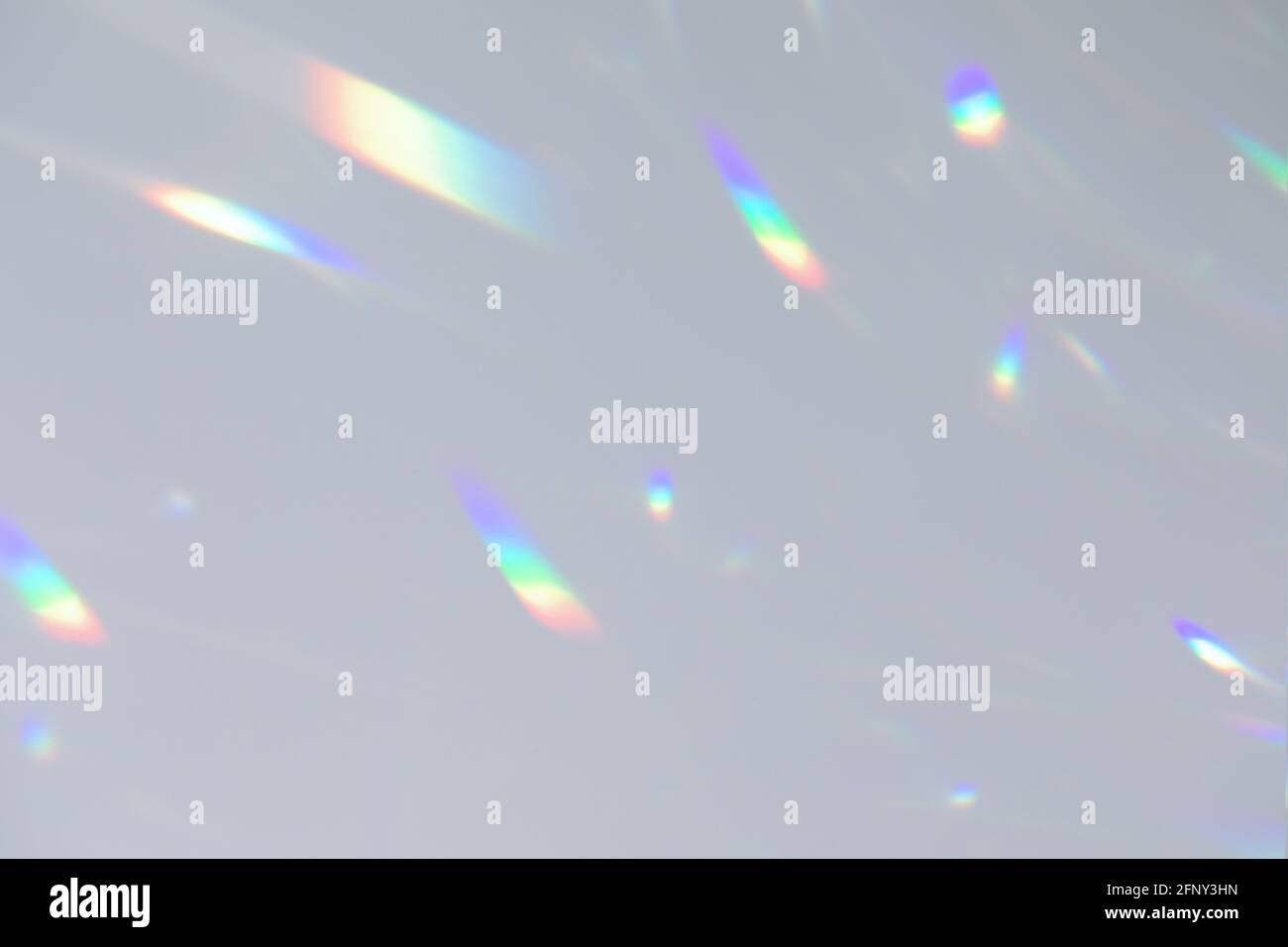 Blurred rainbow light refraction texture on white wall Stock Photo - Alamy