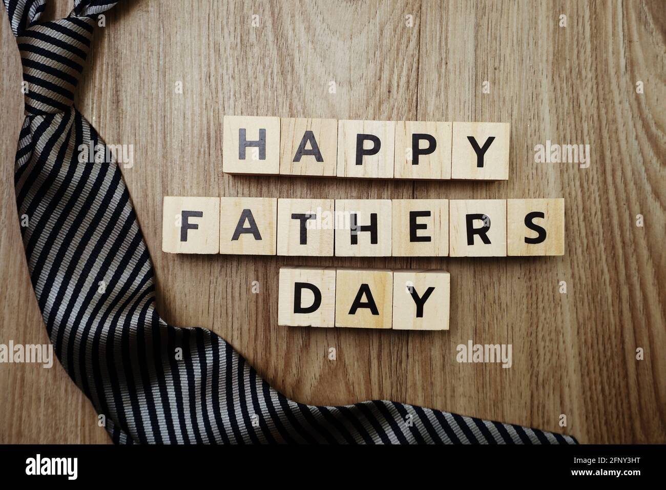 Happy Father's Day alphabet letters with necktie on wooden background ...