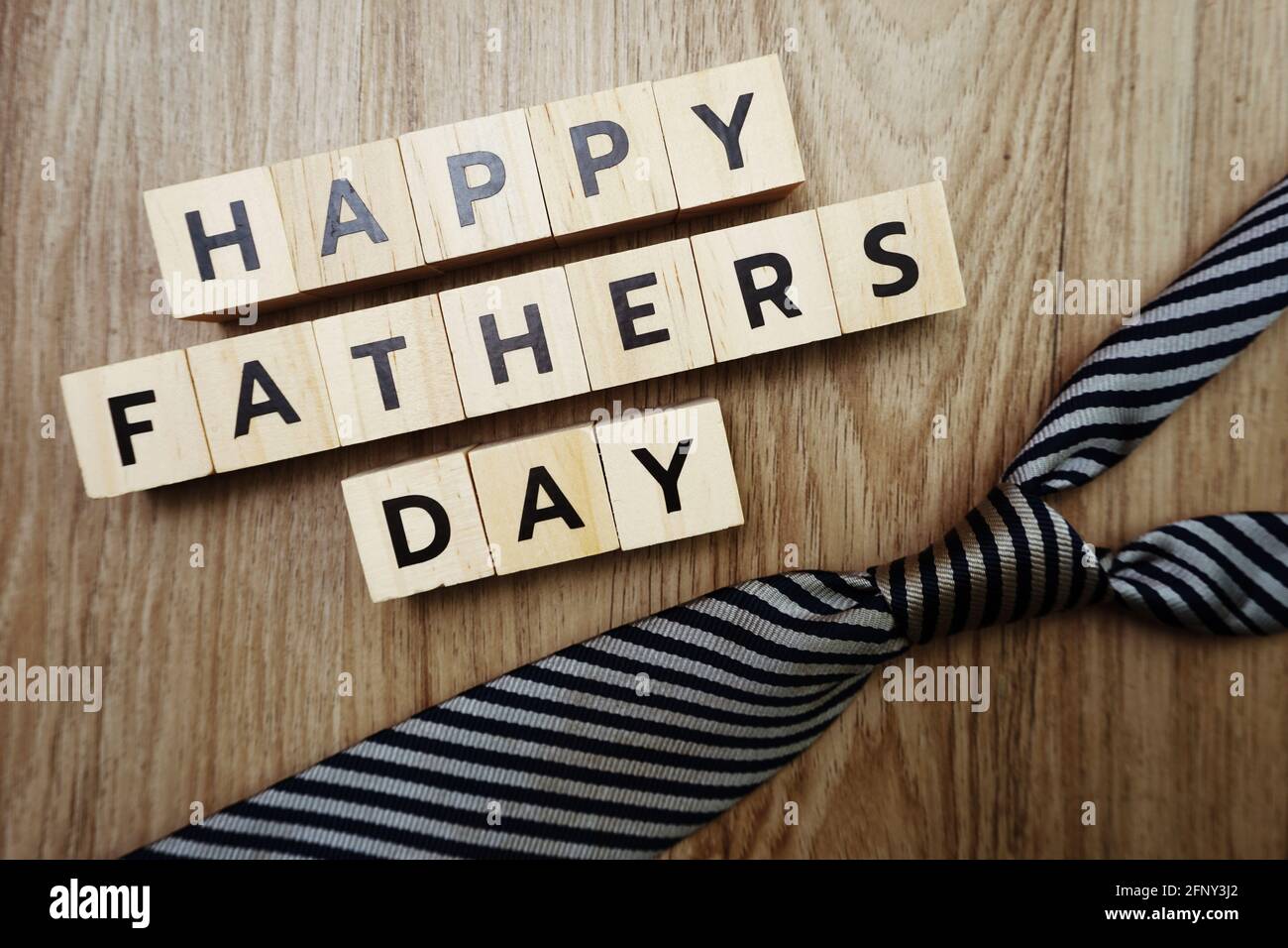Happy Father's Day alphabet letters with necktie on wooden background ...