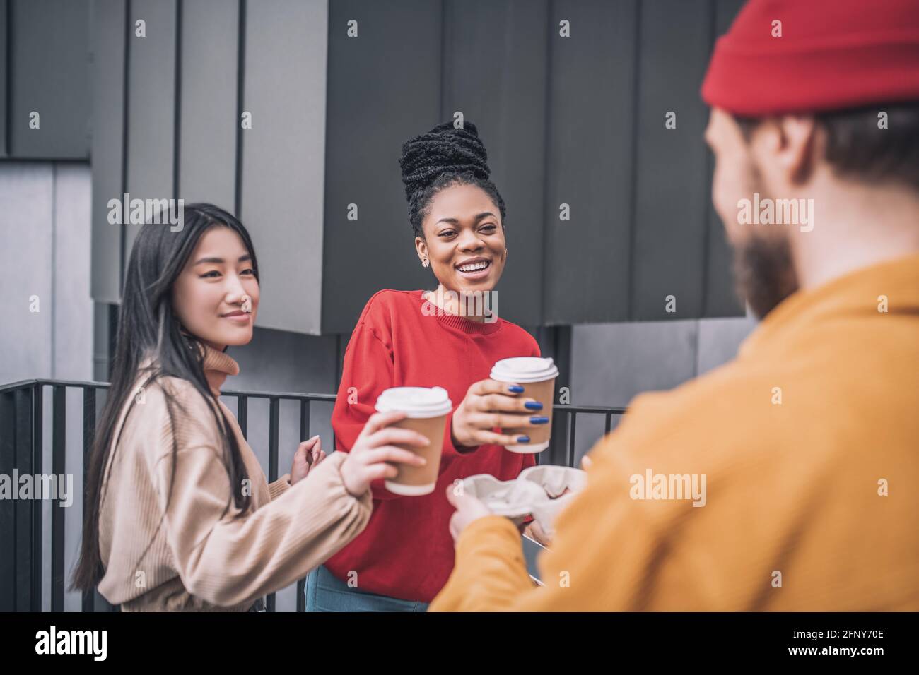 Cheerful friends having break coffee hi-res stock photography and ...