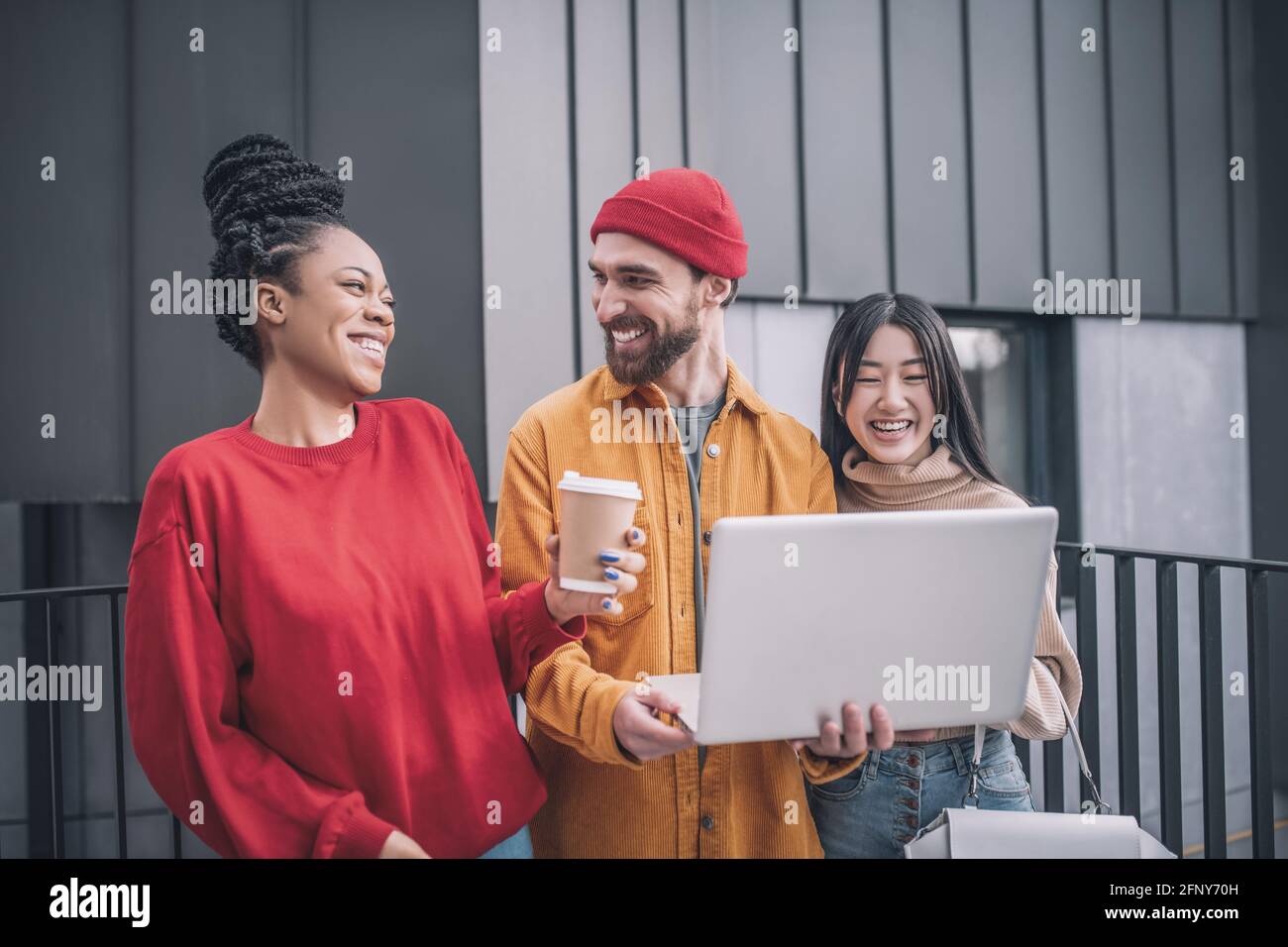 Three friends watching something online and feeling interested Stock ...