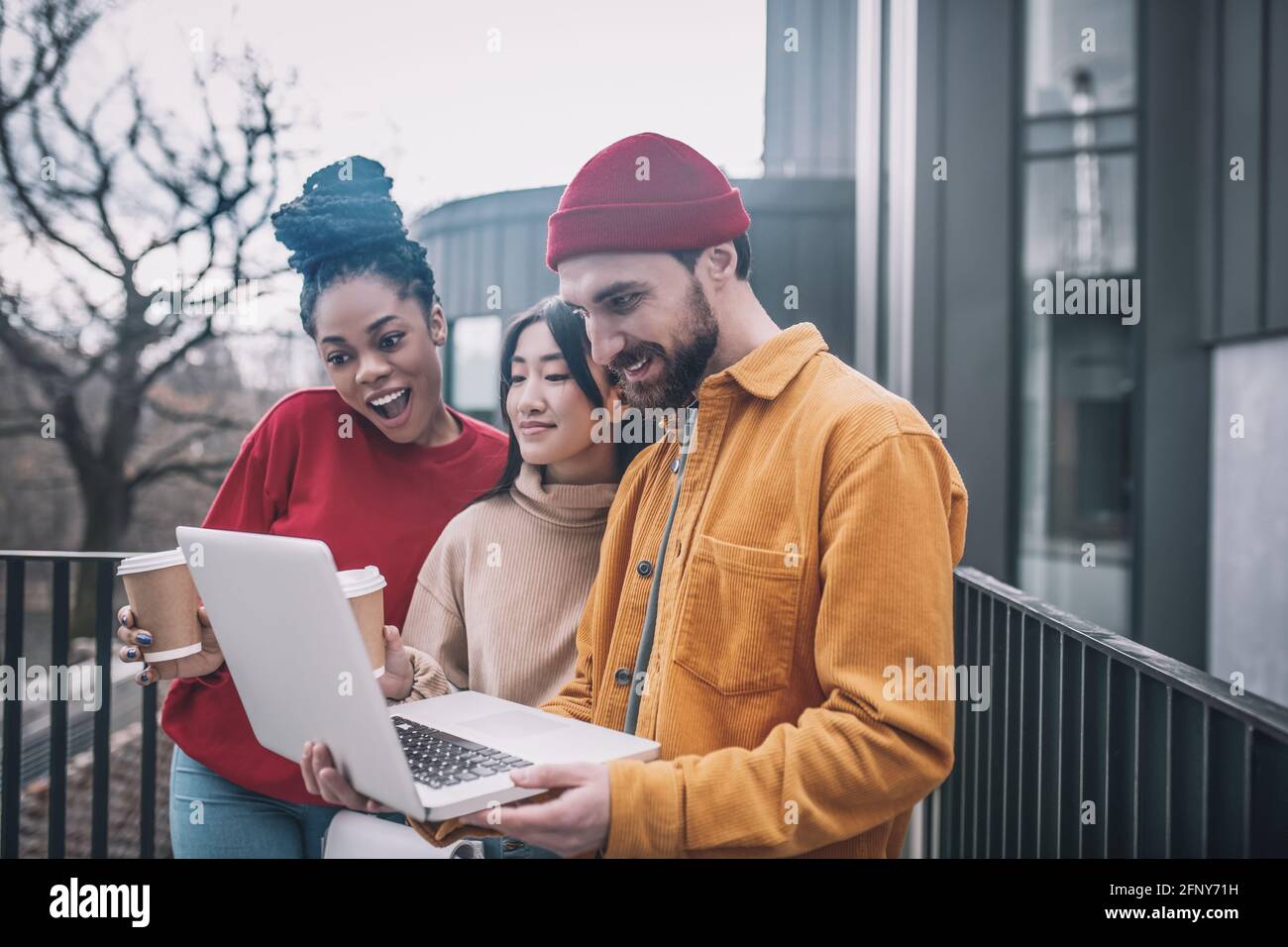 Three friends watching something online and feeling interested Stock ...