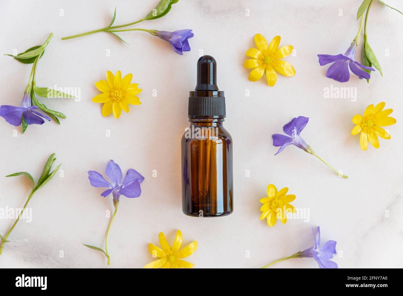 Natural essential oil, serum glass drop bottle on a marble background ...