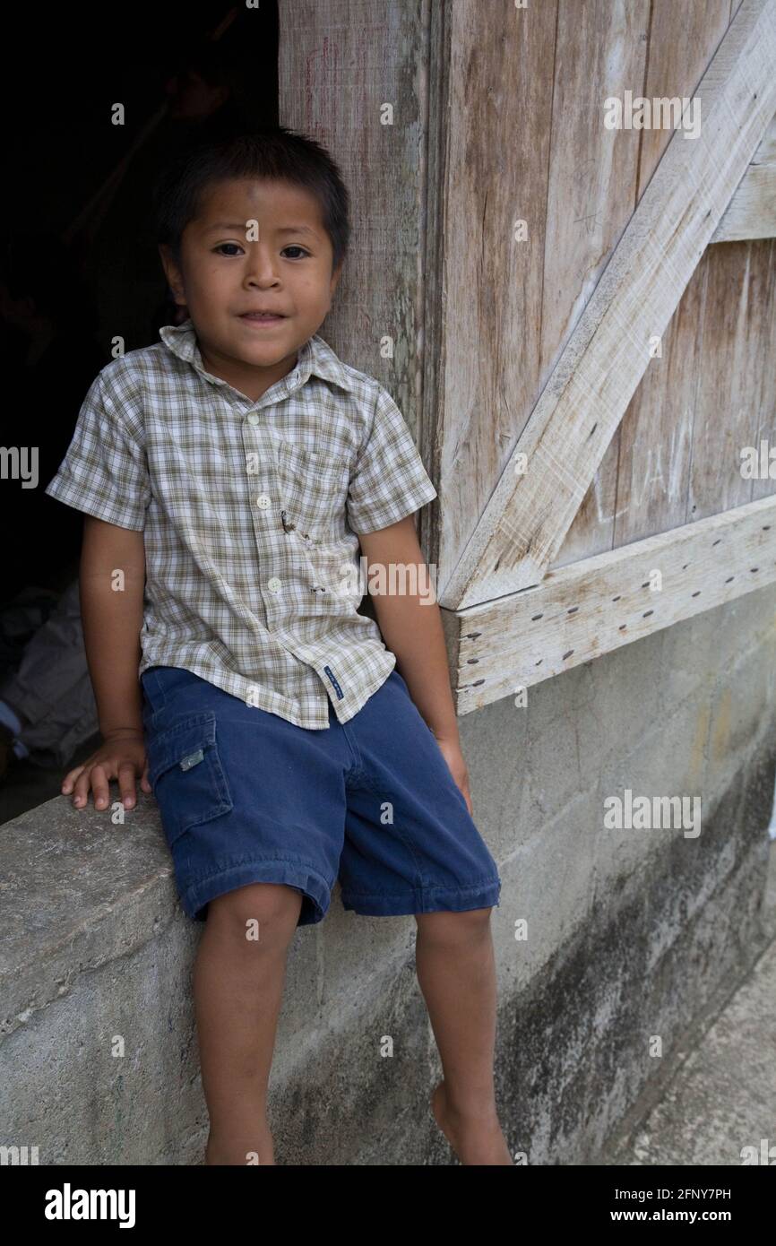 A Mayan boy sits in the window of his house in the Mayan community of ...