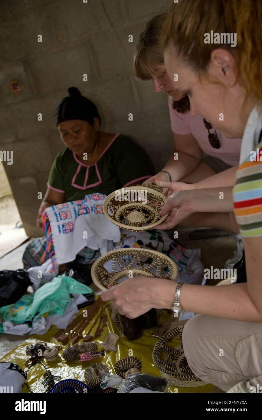 Mayan craftswoman Maria Ack displays her wares to visitors in her home ...