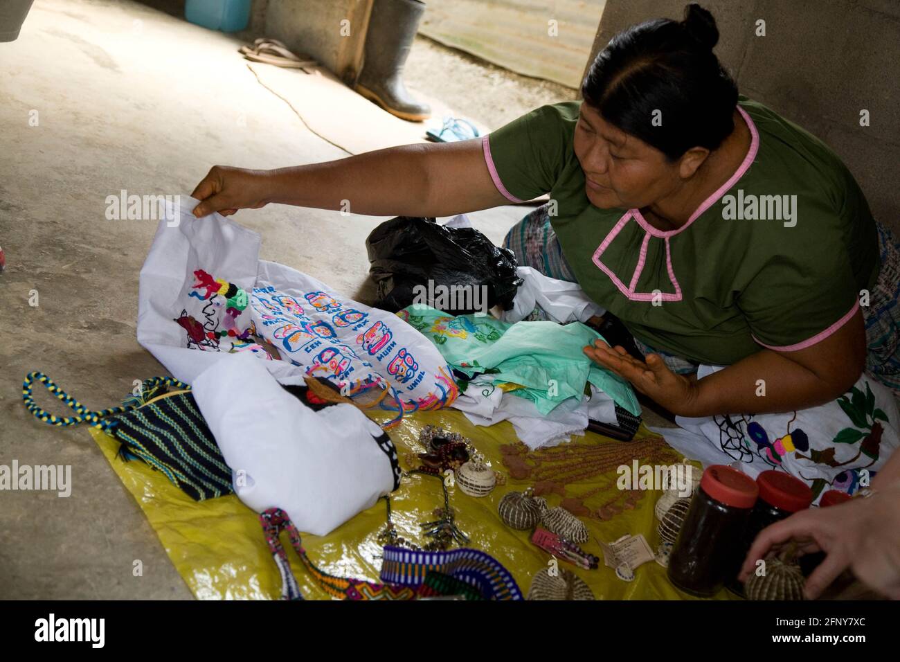 Mayan craftswoman Maria Ack displays her wares to visitors in her home ...