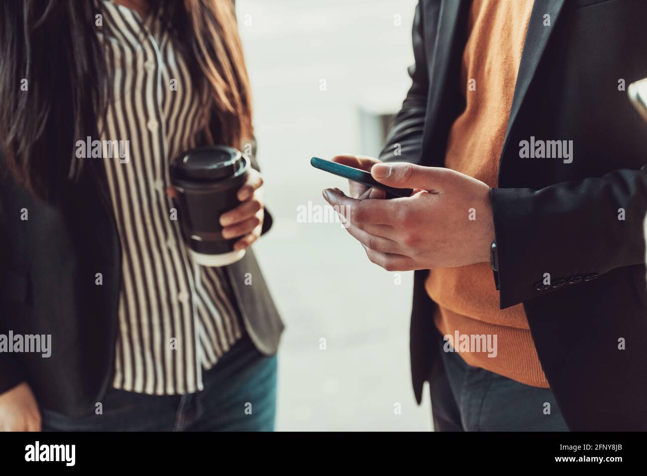 macro photo of young people using the phone during a break from work ...