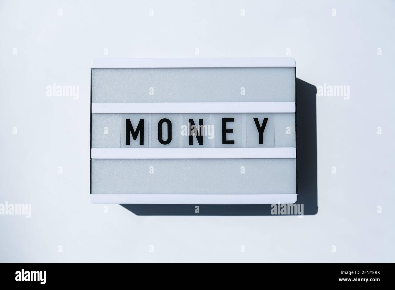 Lightbox board on a white background with the words MONEY in black ...