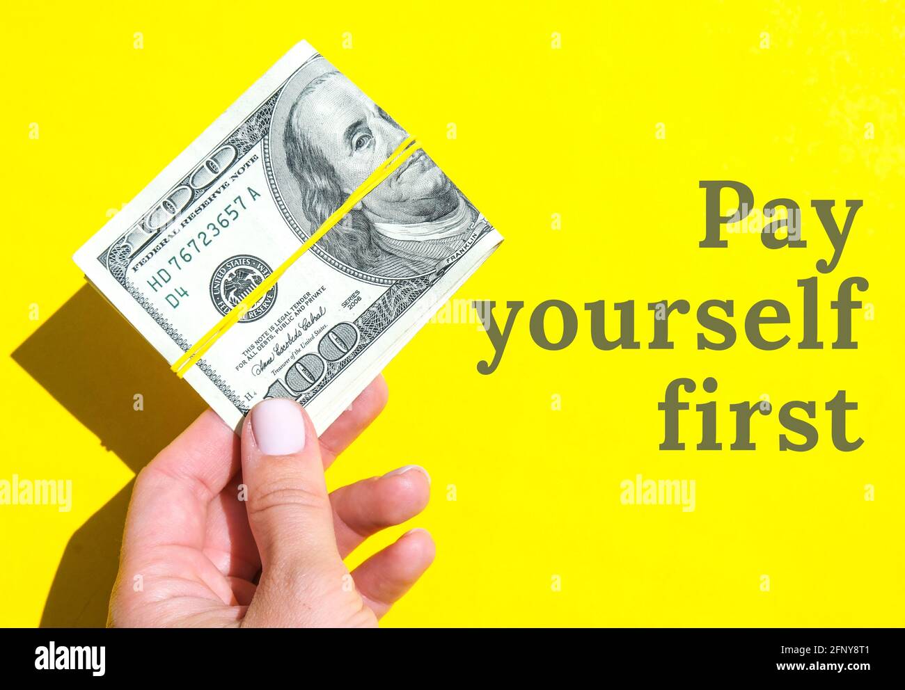 PAY YOURSELF FIRST Quote Female hand holding dollars close up. Money ...