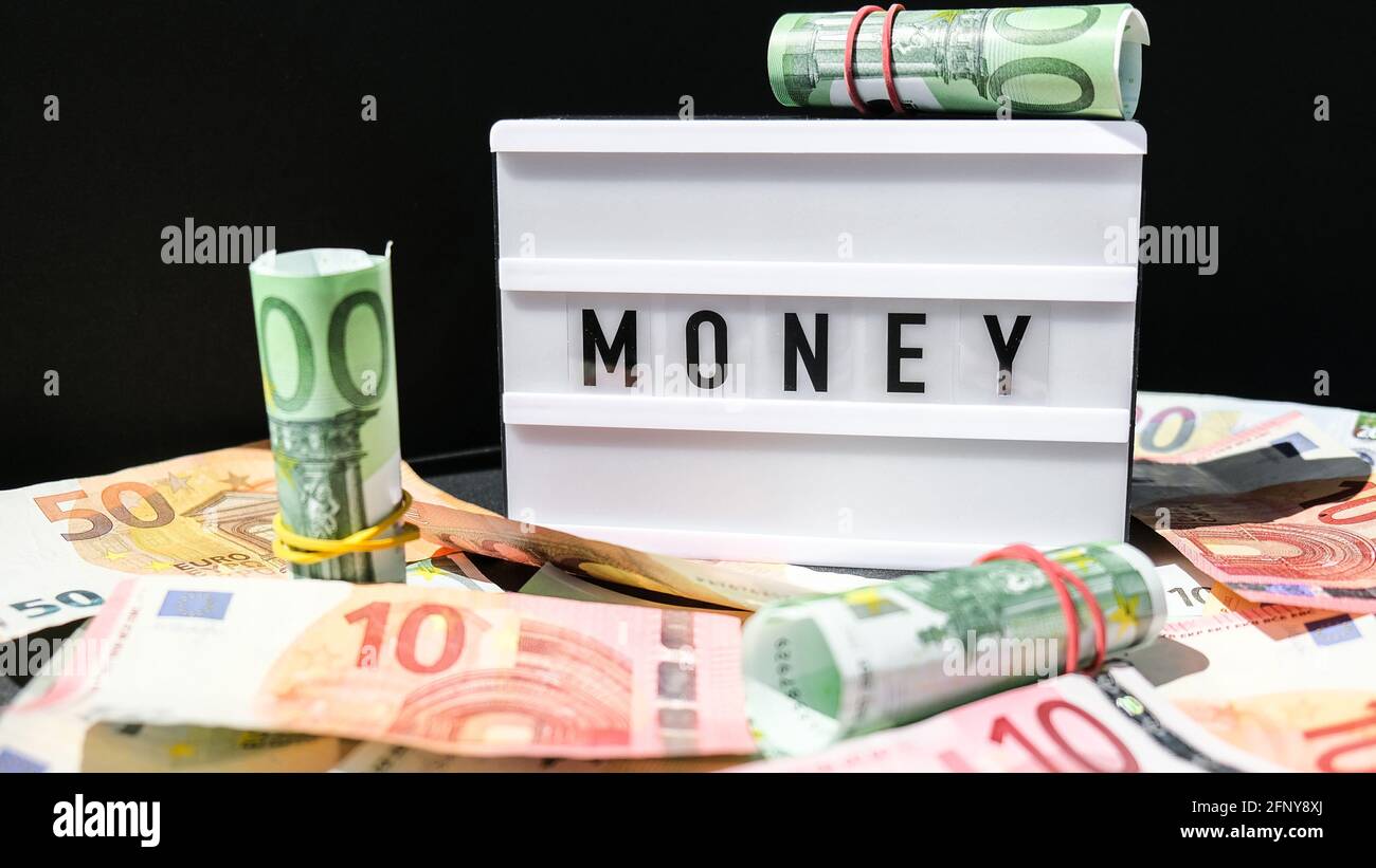 Lightbox board with the word MONEY in black letters around Euro ...