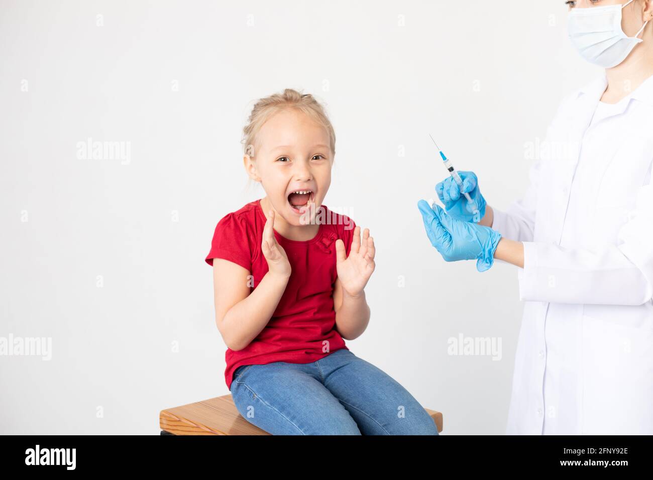 Child scared by a doctor with a syringe Stock Photo - Alamy