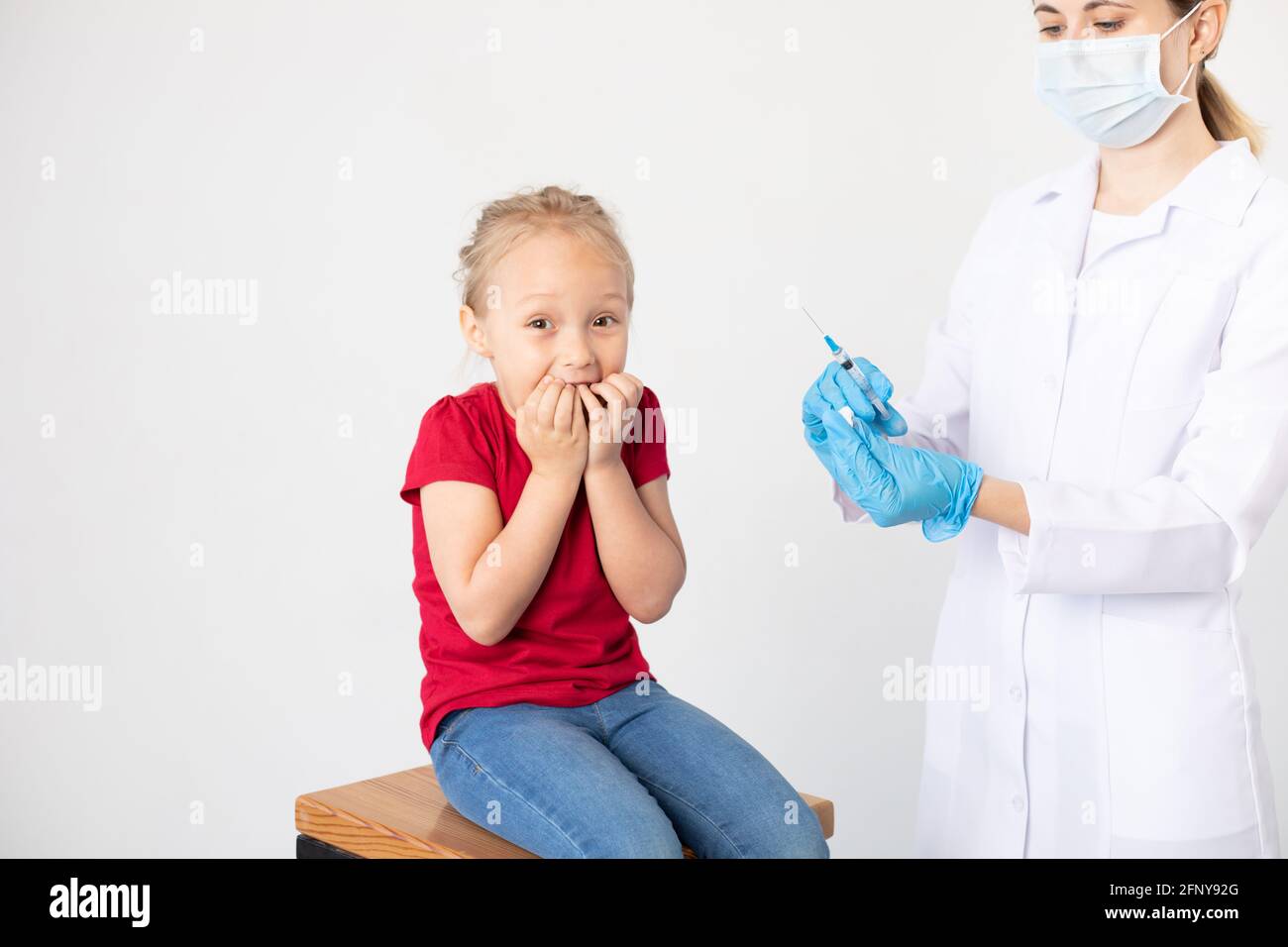Child scared by a doctor with a syringe Stock Photo - Alamy
