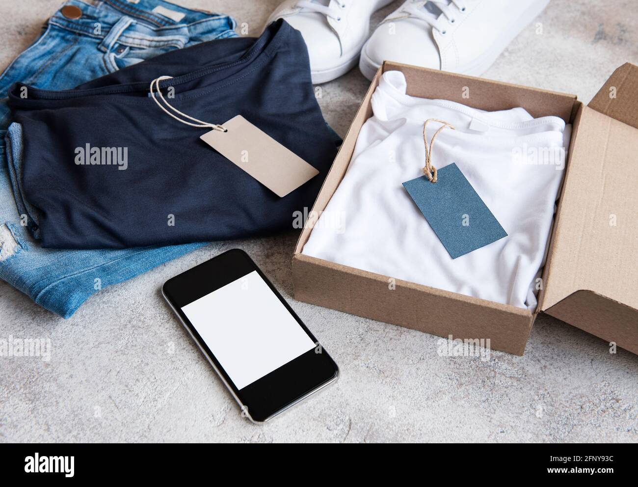 Clothes in an open cardboard box. Online shopping concept. Delivery of ...