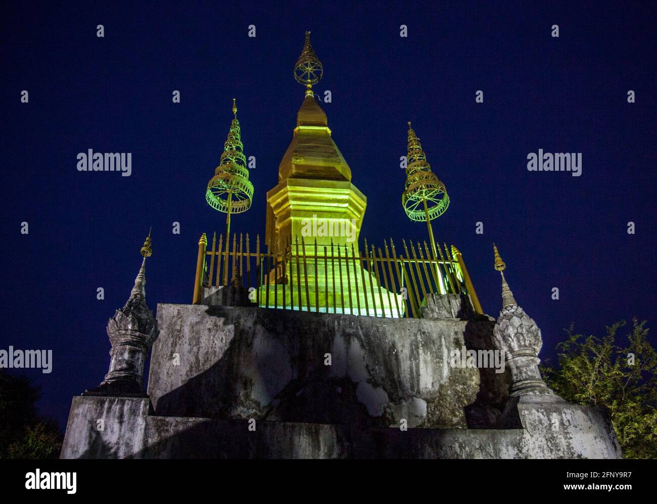 The Golden Stupa of Wat Chom Si / Wat Tham Phousi atop Mount Phousi in ...