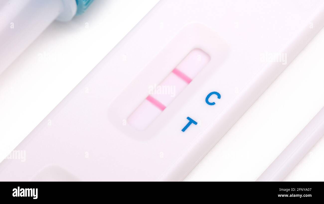 Rapid covid-19 strip test isolated on white - Positive tested Stock ...
