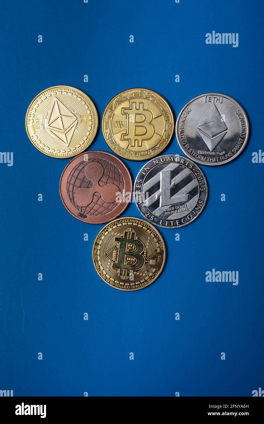 Coins of different cryptocurrencies on a blue background modern virtual ...
